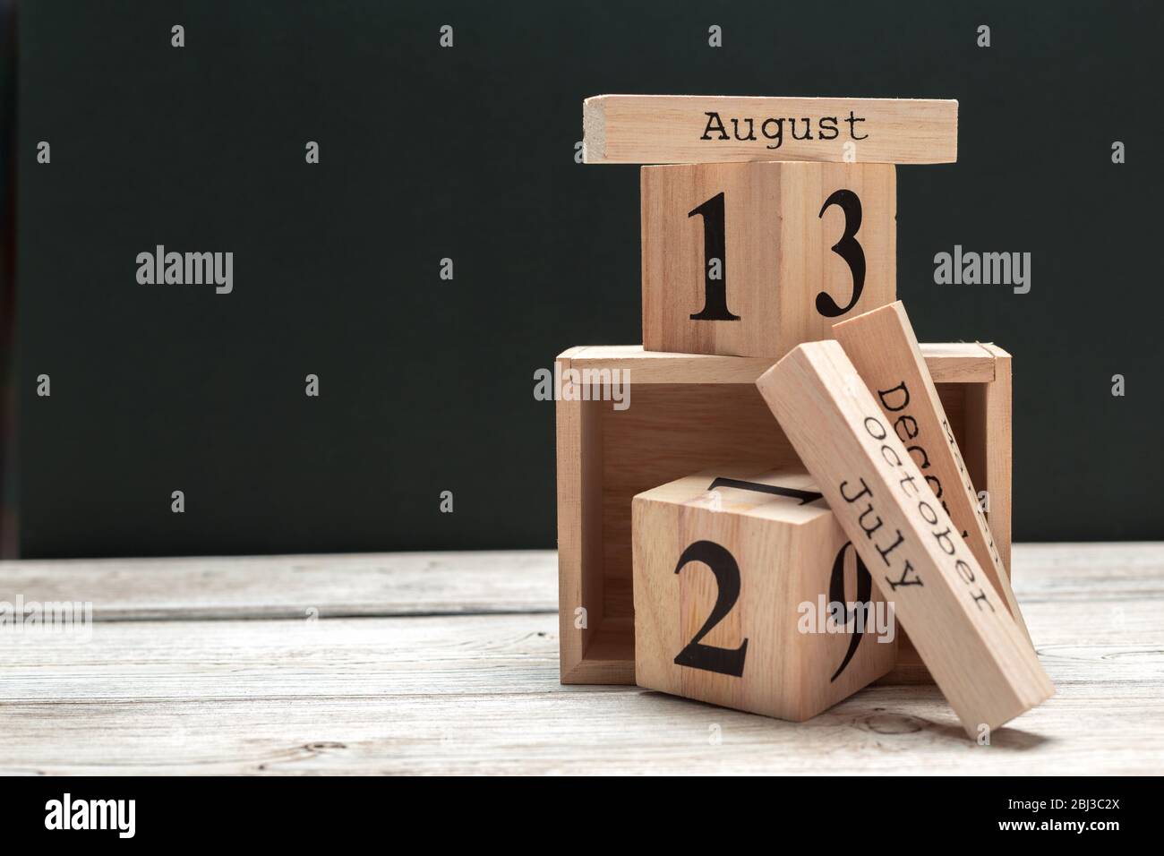 Side view of parts of wooden calendar on dark wooden tabletop Stock ...
