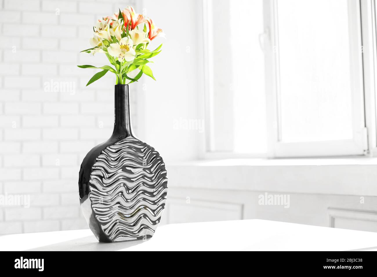 Beautiful spring flowers in vase on window background Stock Photo - Alamy