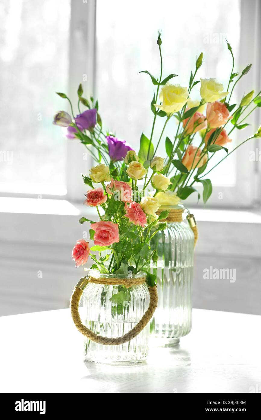 Beautiful spring flowers in vase on window background Stock Photo - Alamy