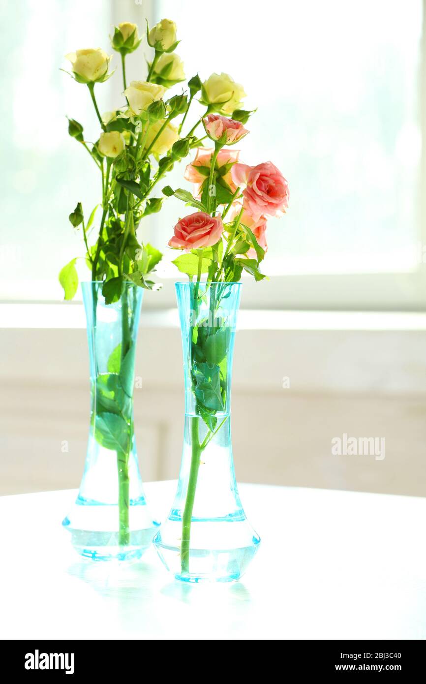 Beautiful spring flowers in vase on window background Stock Photo - Alamy