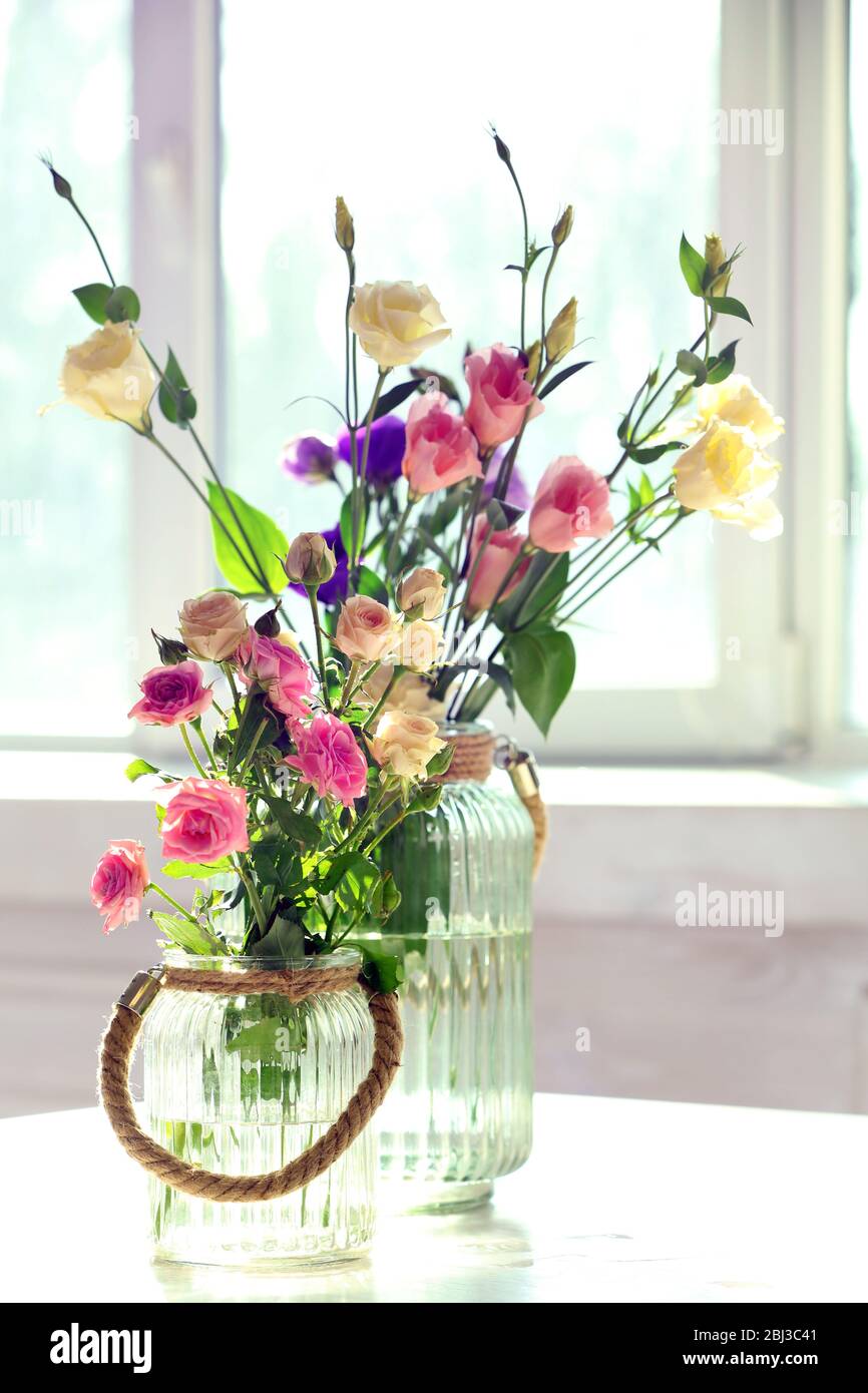 Beautiful spring flowers in vase on window background Stock Photo - Alamy