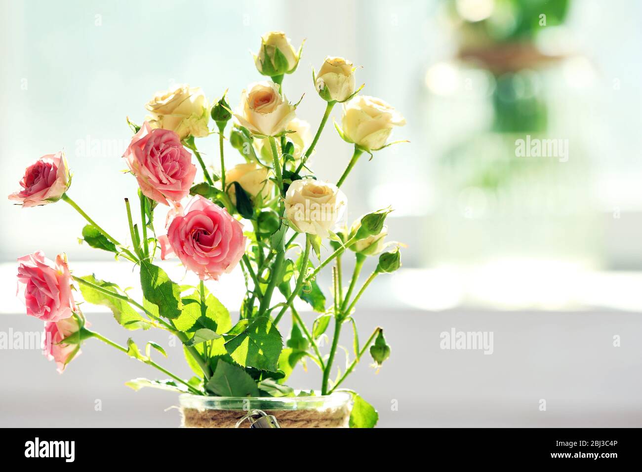 Beautiful spring flowers in vase on window background Stock Photo - Alamy