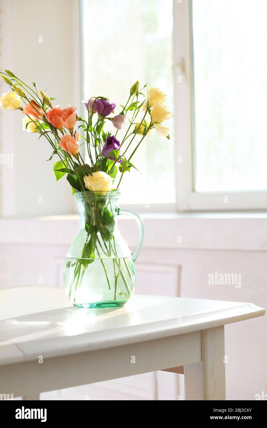 Beautiful spring flowers in vase on window background Stock Photo - Alamy
