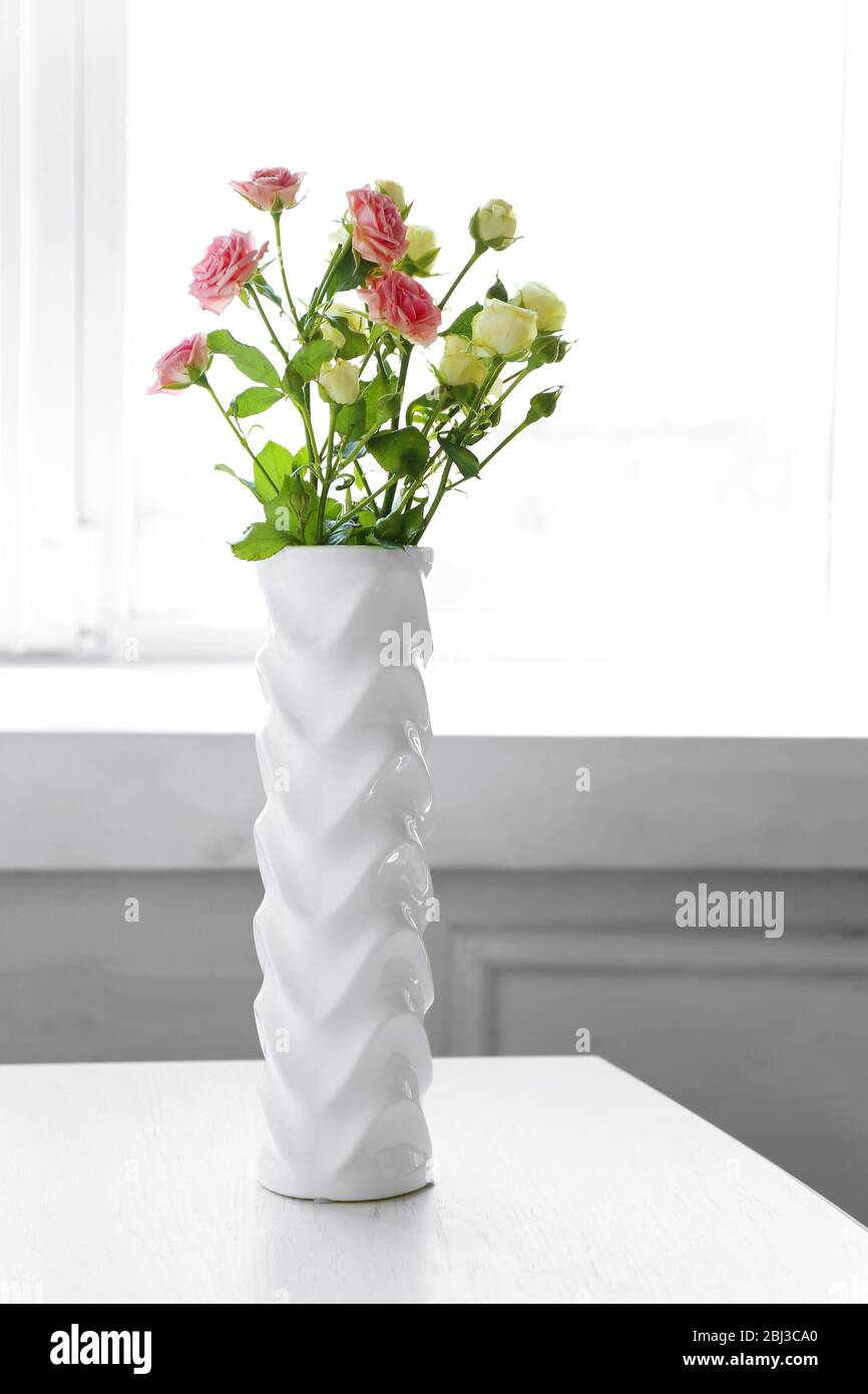 Beautiful spring flowers in vase on window background Stock Photo - Alamy