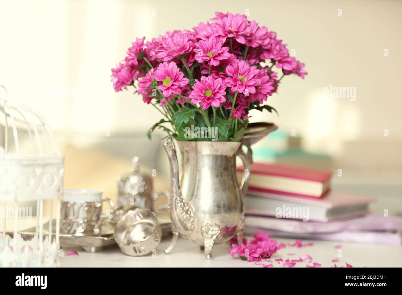 Beautiful flowers in vase on table in room Stock Photo - Alamy