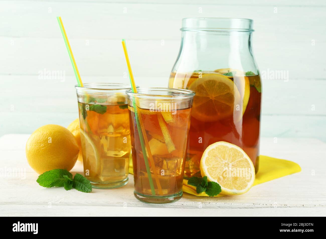 Iced tea with lemon on light wooden background Stock Photo - Alamy