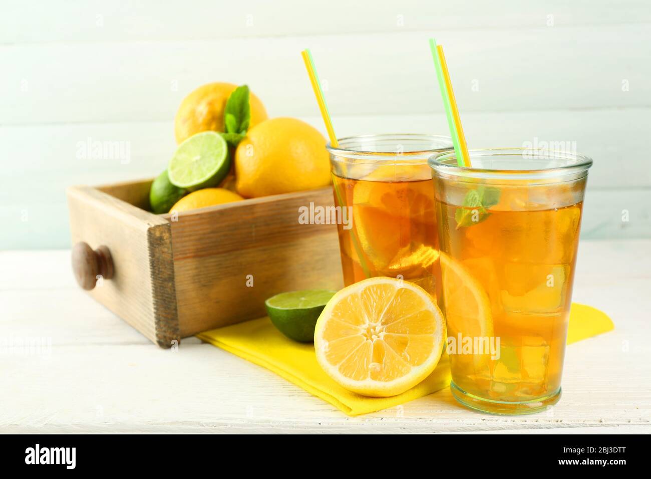 Iced tea with lemon on light wooden background Stock Photo - Alamy