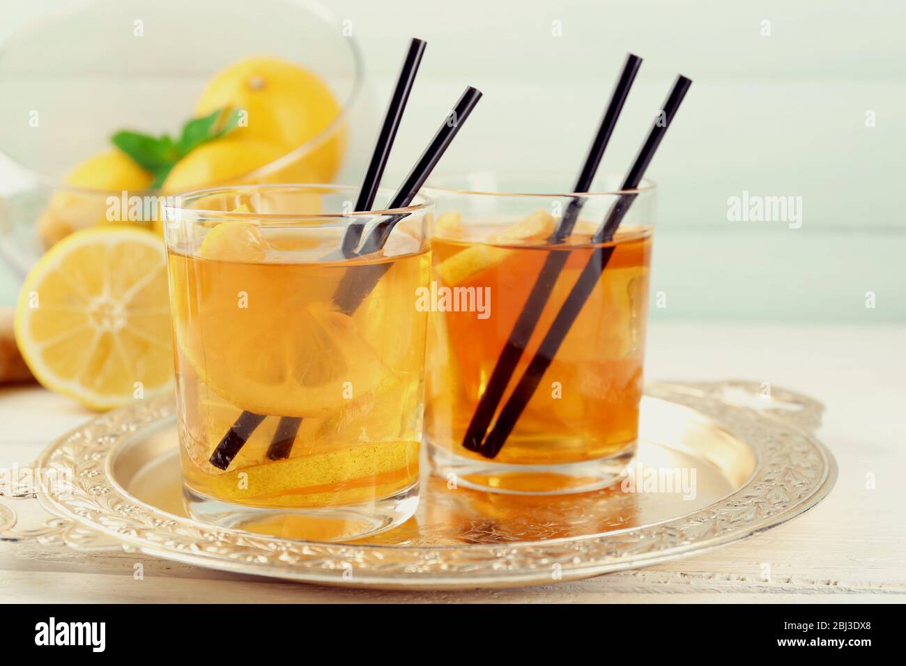 Iced tea with lemon on light wooden background Stock Photo - Alamy
