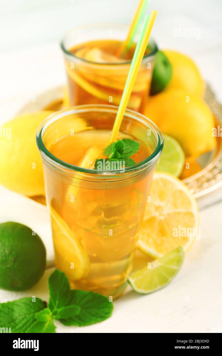 Iced tea with lemon on light wooden background Stock Photo - Alamy