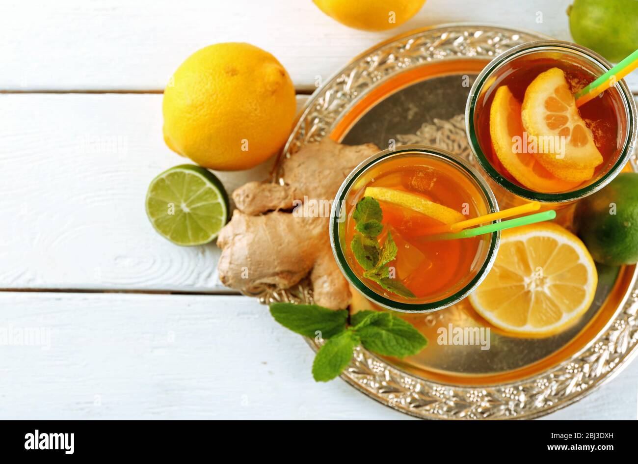 Iced tea with lemon on light wooden background Stock Photo - Alamy