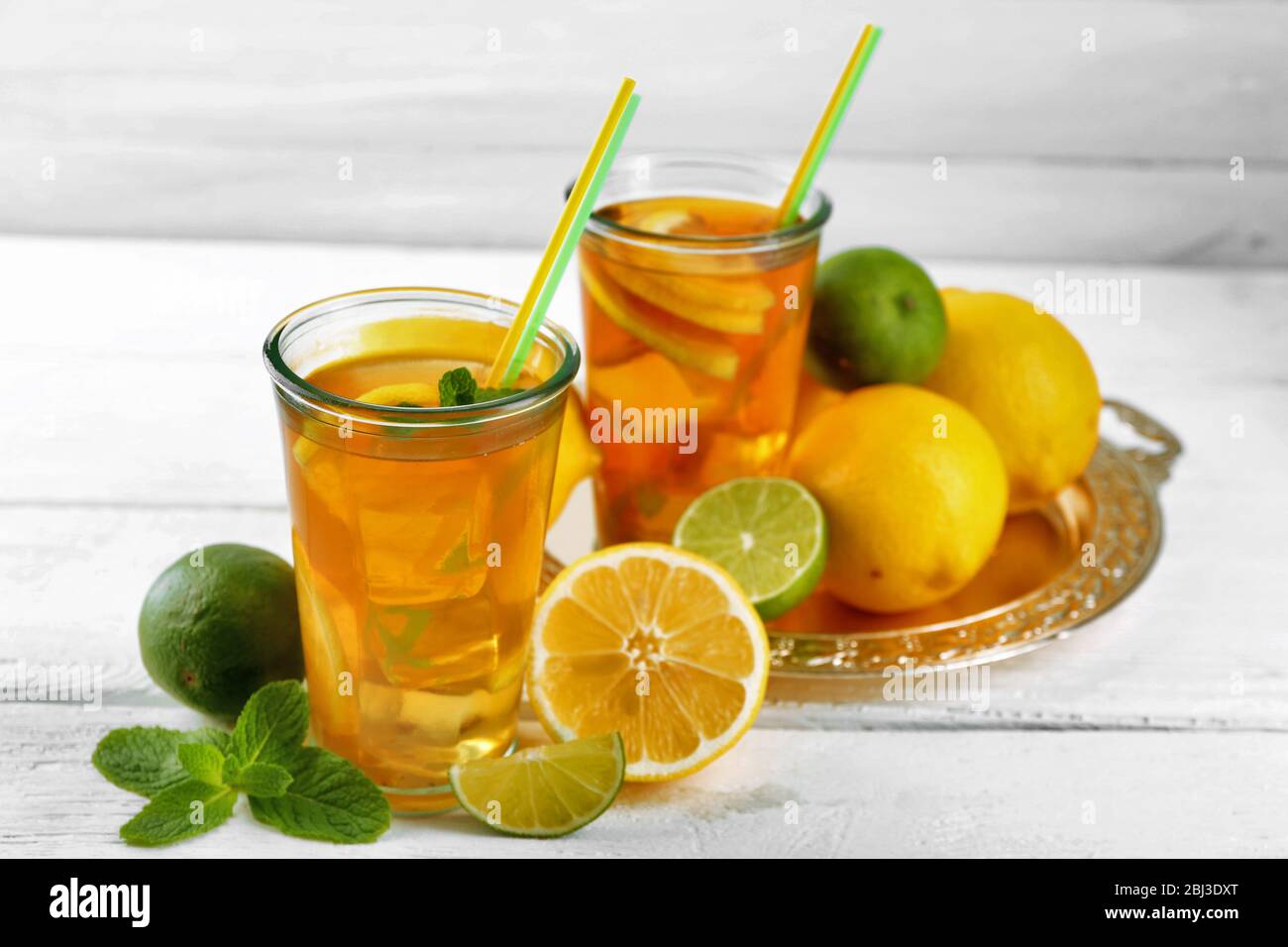 Iced tea with lemon on light wooden background Stock Photo - Alamy