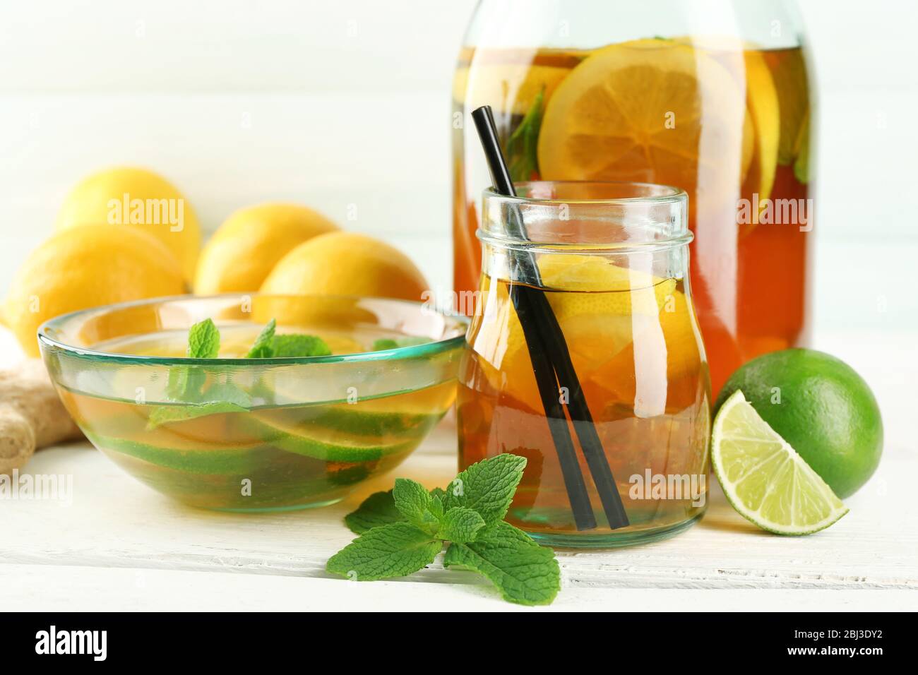 Iced tea with lemon on light wooden background Stock Photo - Alamy