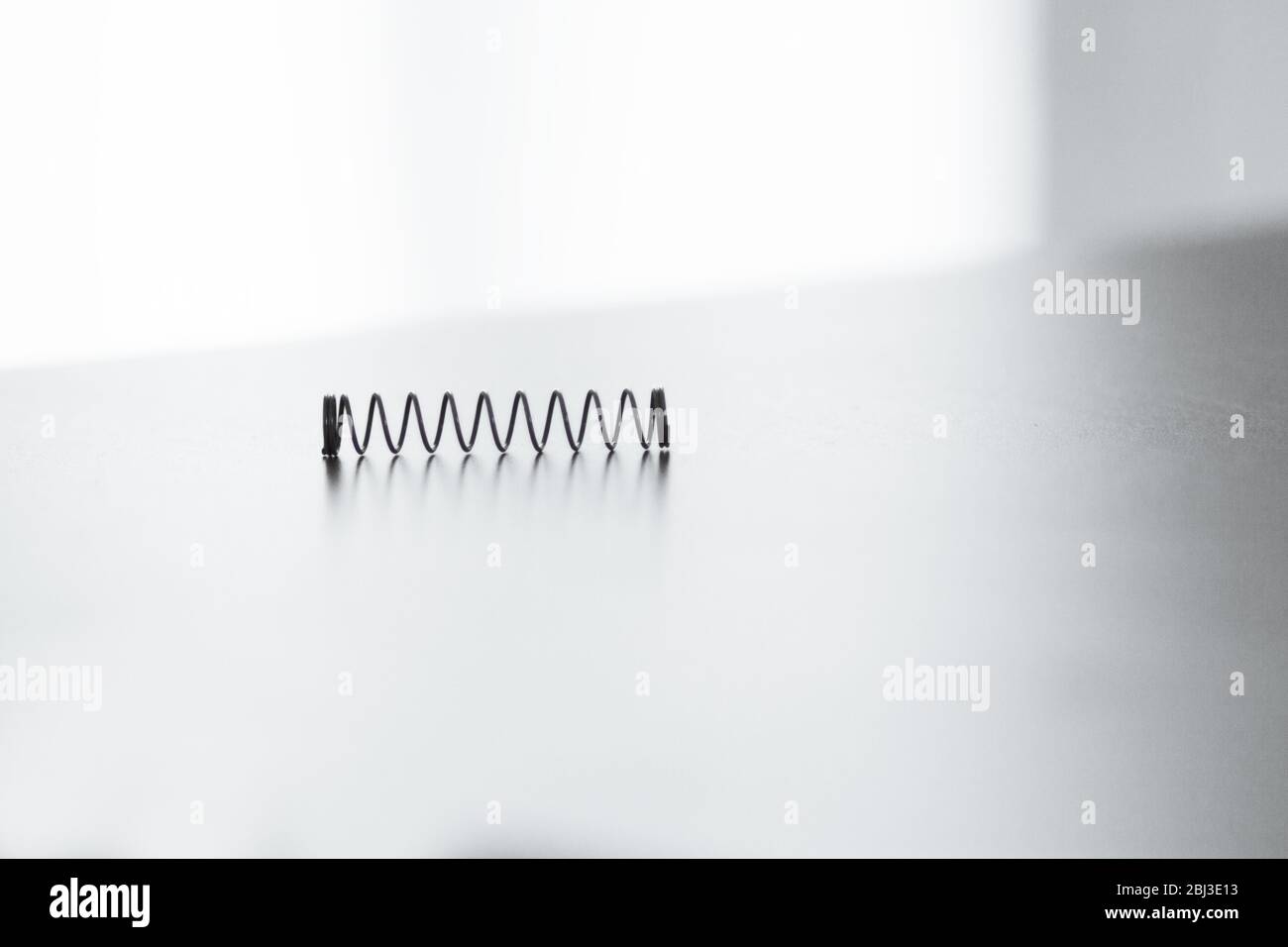 Small wire spring of a ballpoint pen. No people Stock Photo - Alamy
