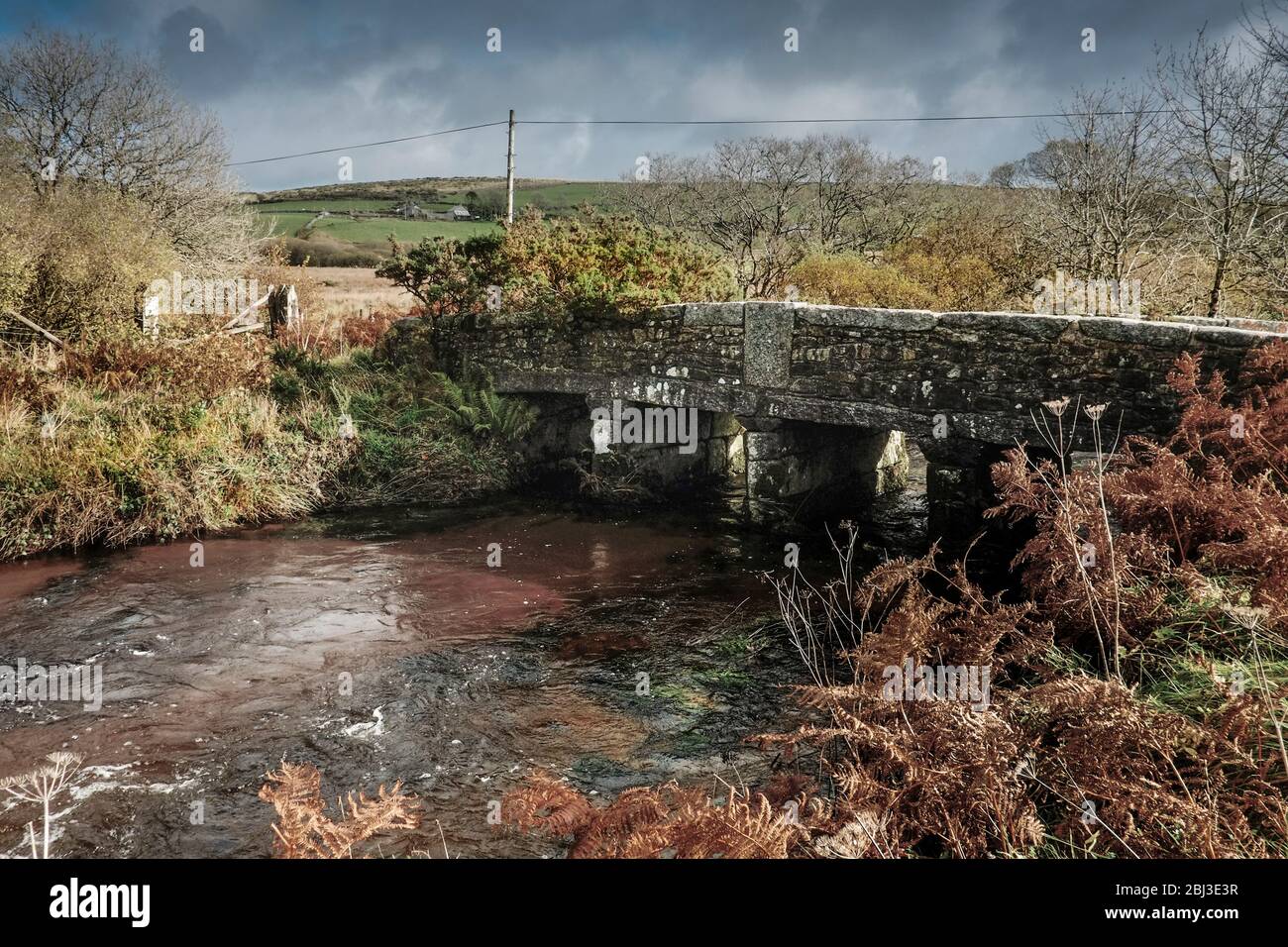 An old disused historic stone bridge over the River Fowey at Ninestones ...