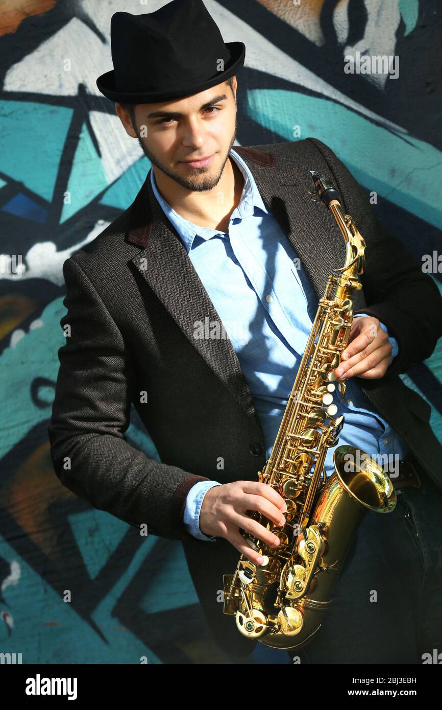 Young man playing saxophone paint hi-res stock photography and images ...