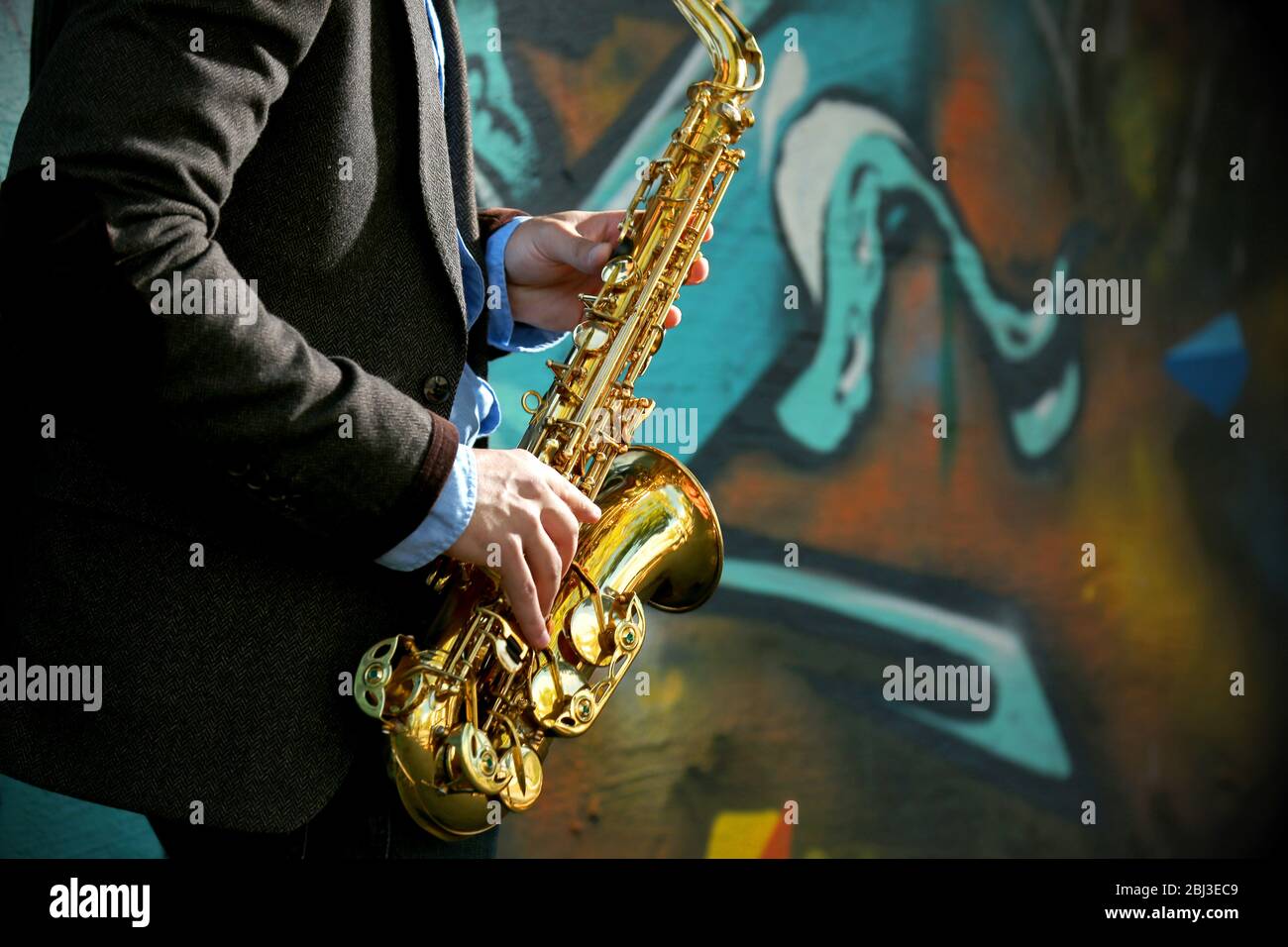 Young man playing saxophone paint hi-res stock photography and images ...