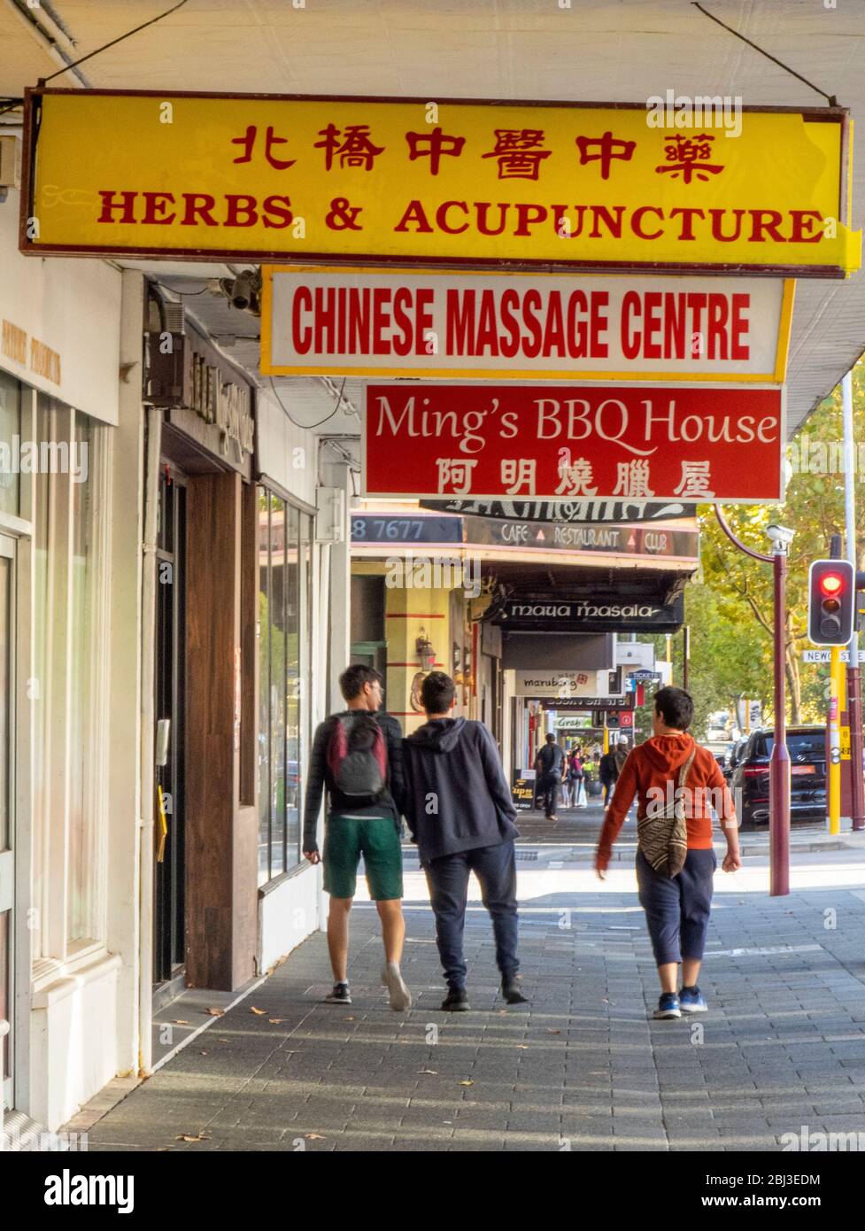 Three pedestrians walking along William Street in Chinatown Northbridge ...