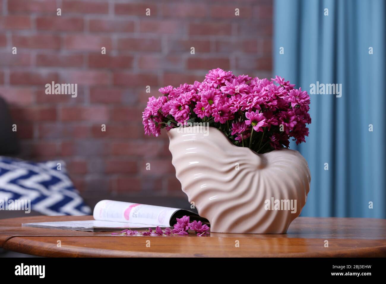Beautiful flowers in vase on table in room Stock Photo - Alamy
