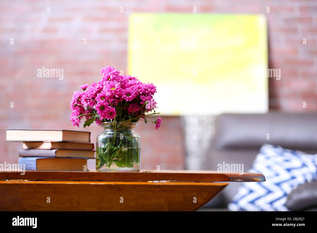 Beautiful flowers in vase on table in room Stock Photo - Alamy