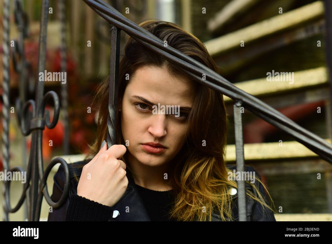 Woman with strict face on stone stairs. Fashion model on caracole ...