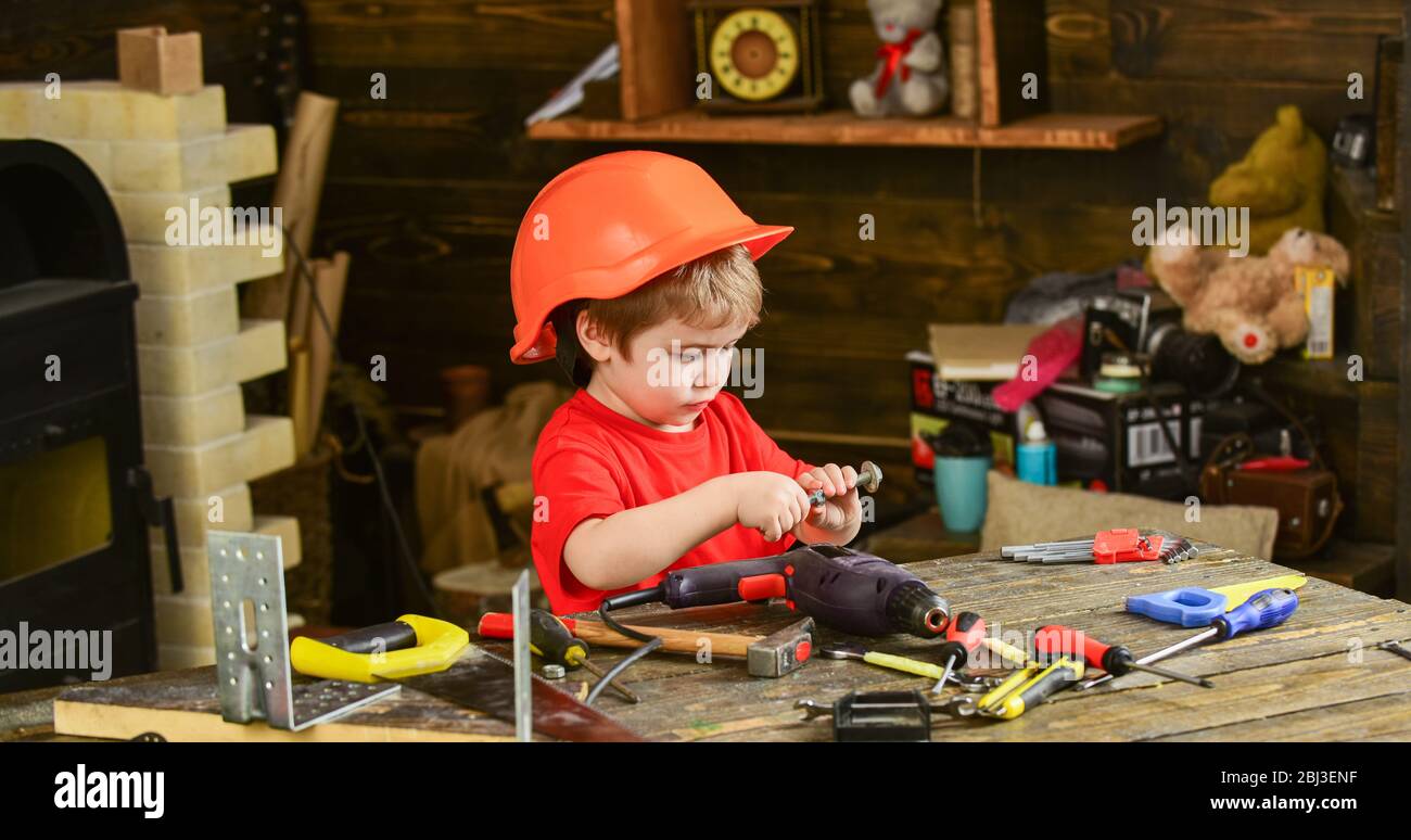 Little helper in workshop. Side view kid playing with screw bolts. Boy ...