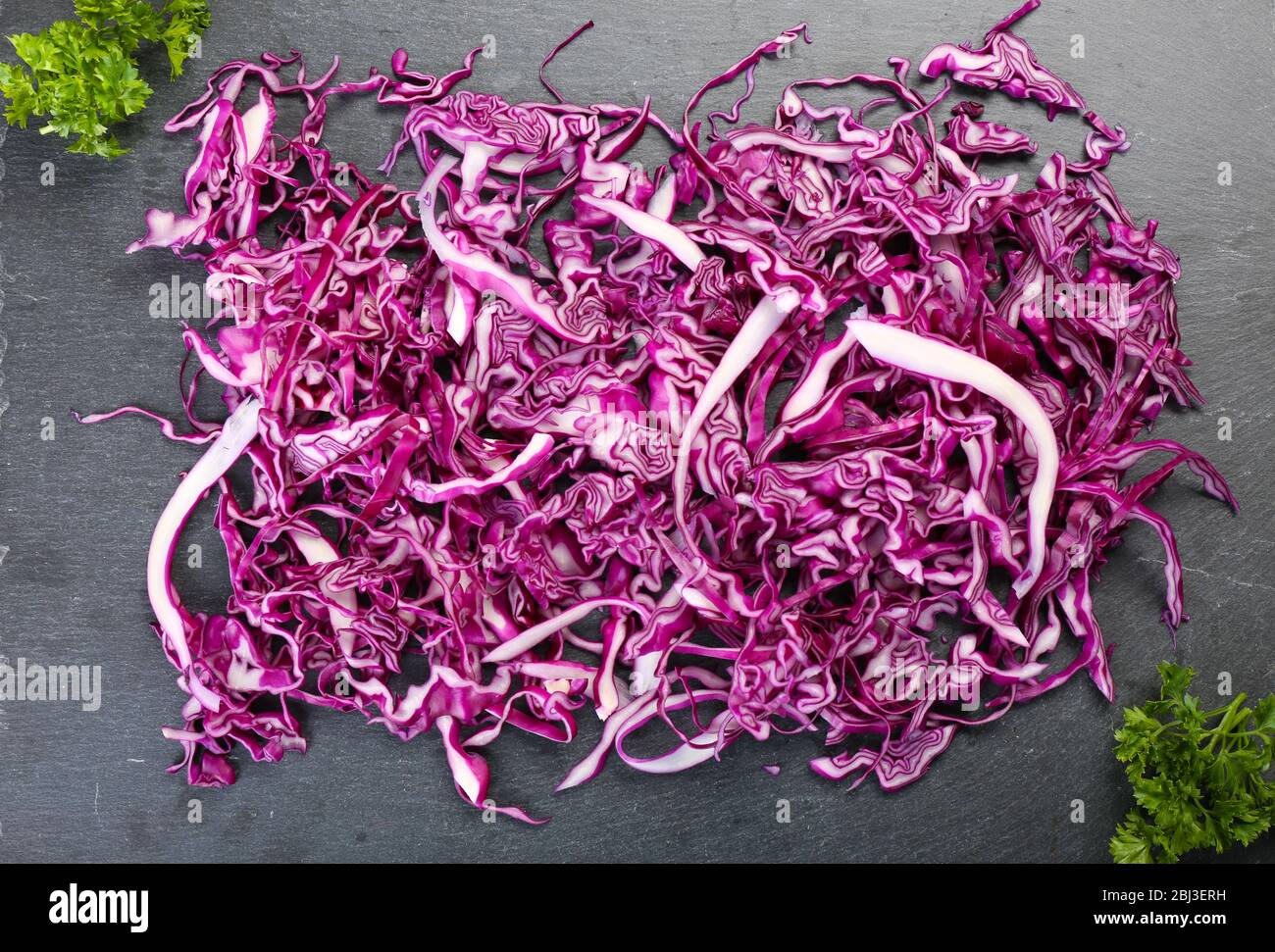 Cut red cabbage on wooden table Stock Photo - Alamy