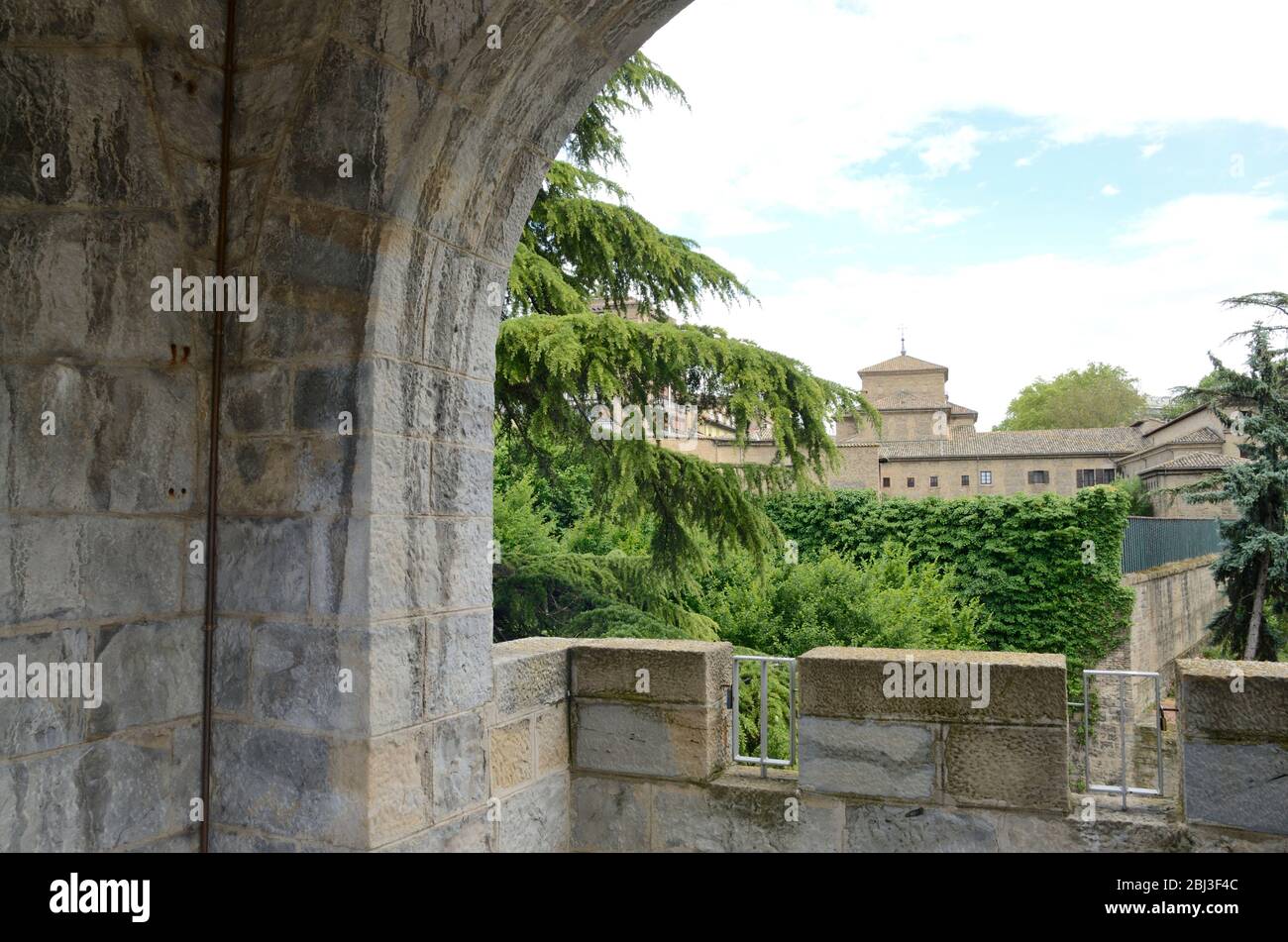 Historic building seen through stone arch in Pamplona, the capital of ...