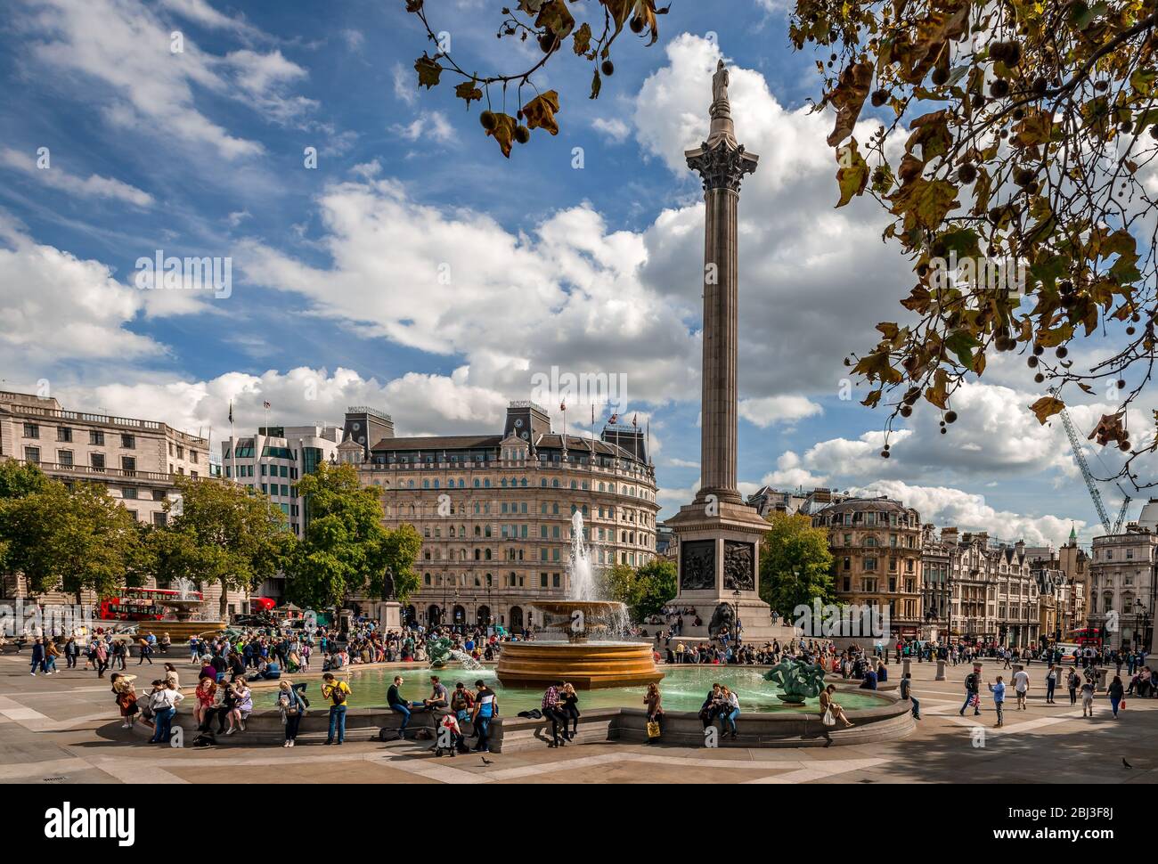 London / UK - September 15 2018: People enjoy the sunshine in Trafalgar ...