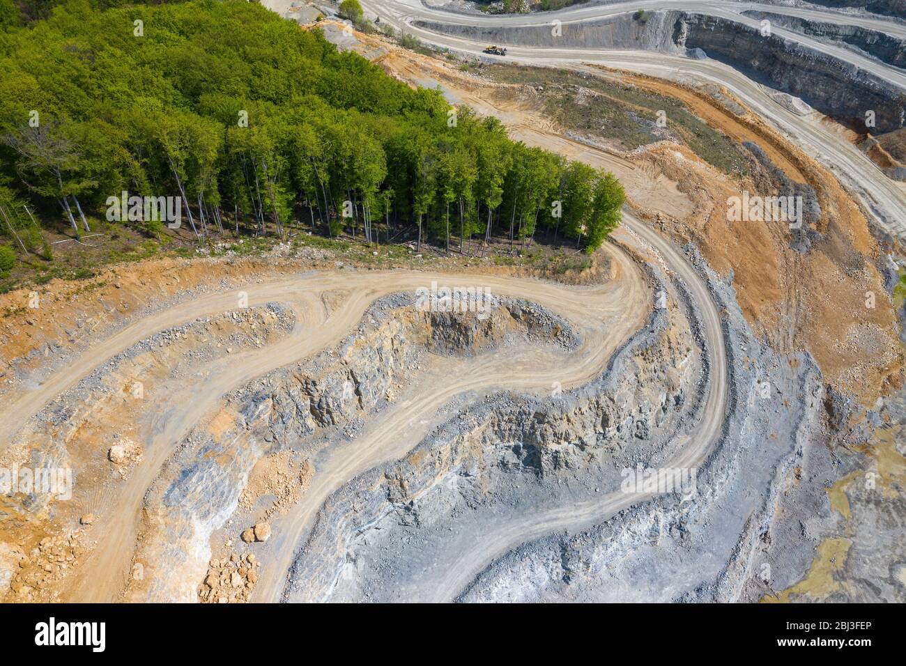Mining from above. Industrial terraces on open pit mineral mine. Aerial ...