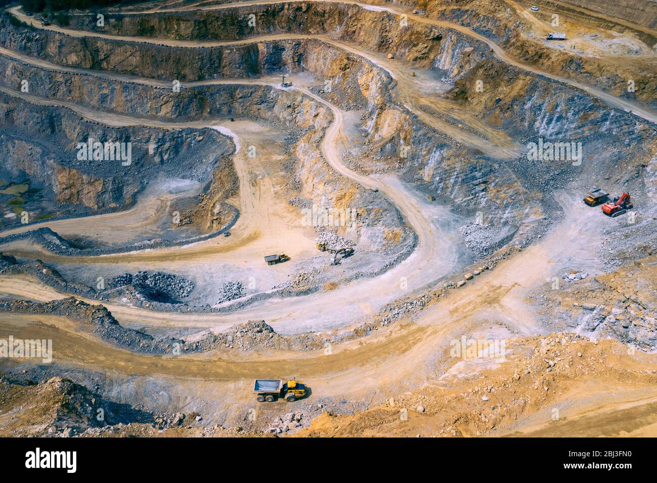 Mining from above. Industrial terraces on open pit mineral mine. Aerial ...