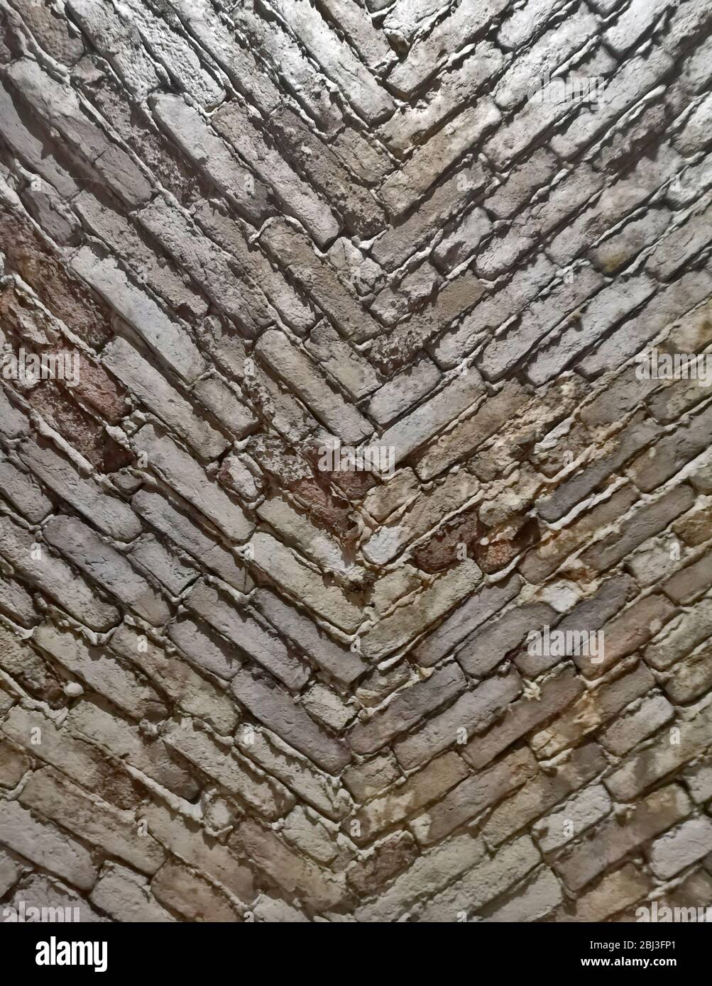A vertical background with stone bricks in a downward facing v shape ...
