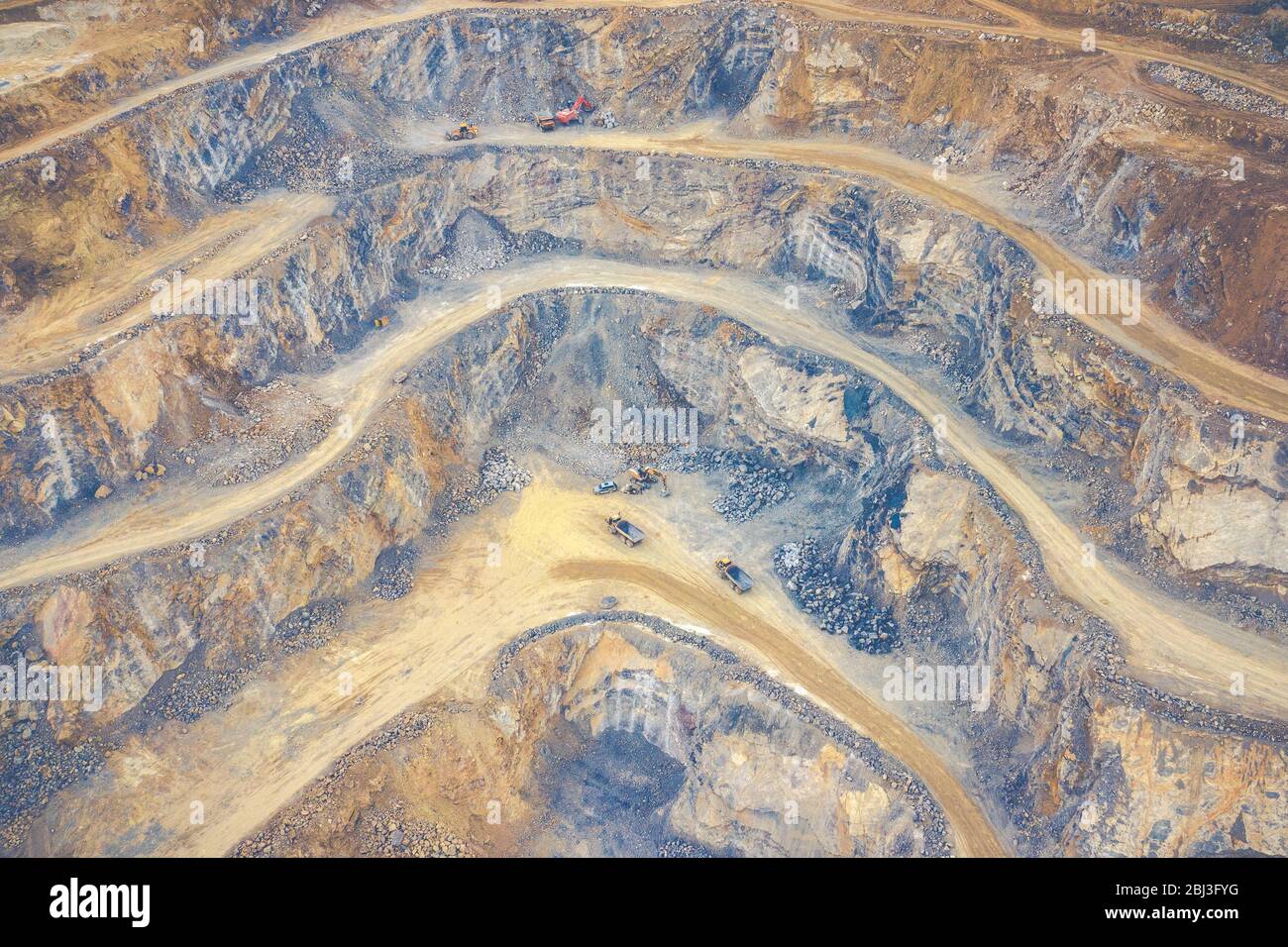 Mining from above. Industrial terraces on open pit mineral mine. Aerial ...