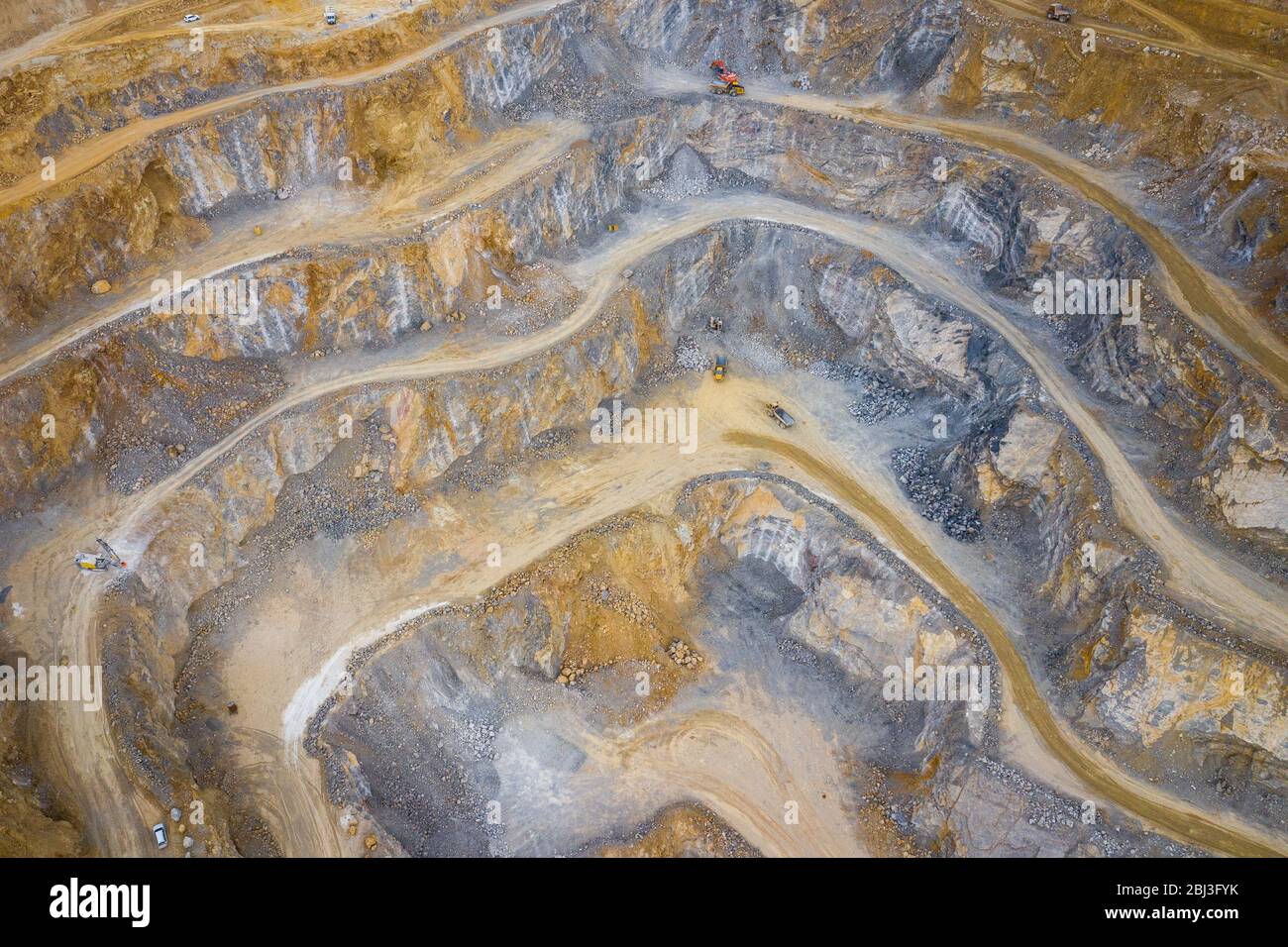 Mining from above. Industrial terraces on open pit mineral mine. Aerial ...