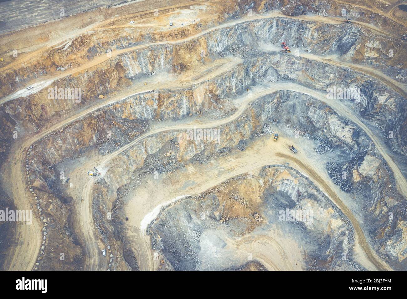 Mining from above. Industrial terraces on open pit mineral mine. Aerial ...