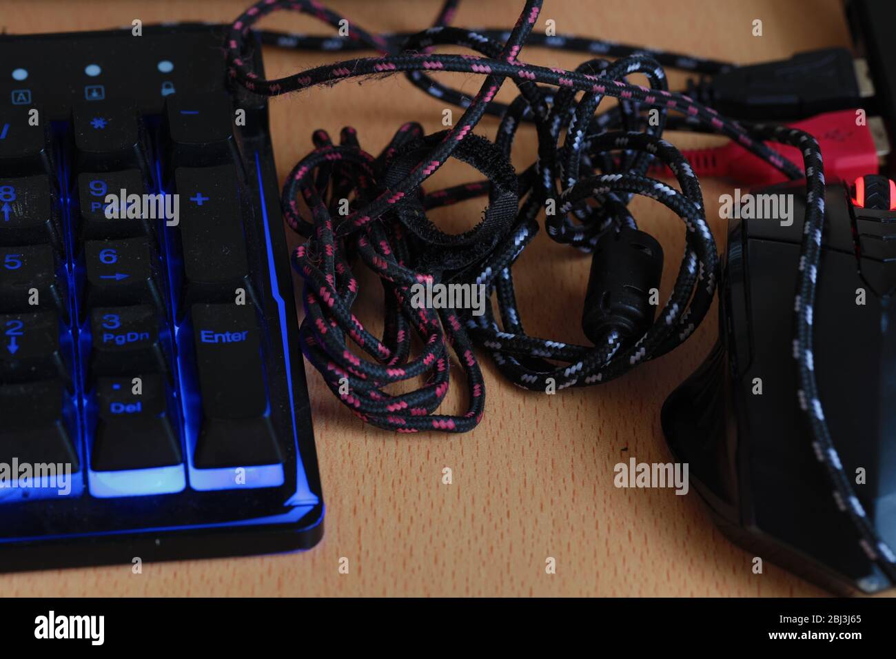 Concept consisting of mouse, keyboard and cables. Cables tangled ...