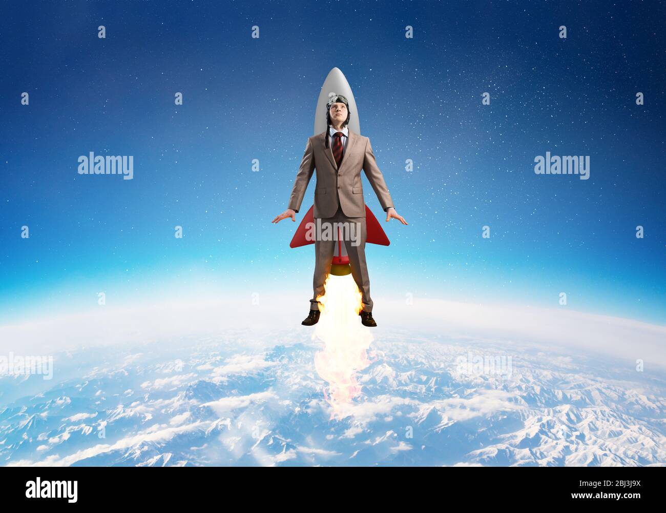 Business person in aviator hat flying on rocket Stock Photo - Alamy