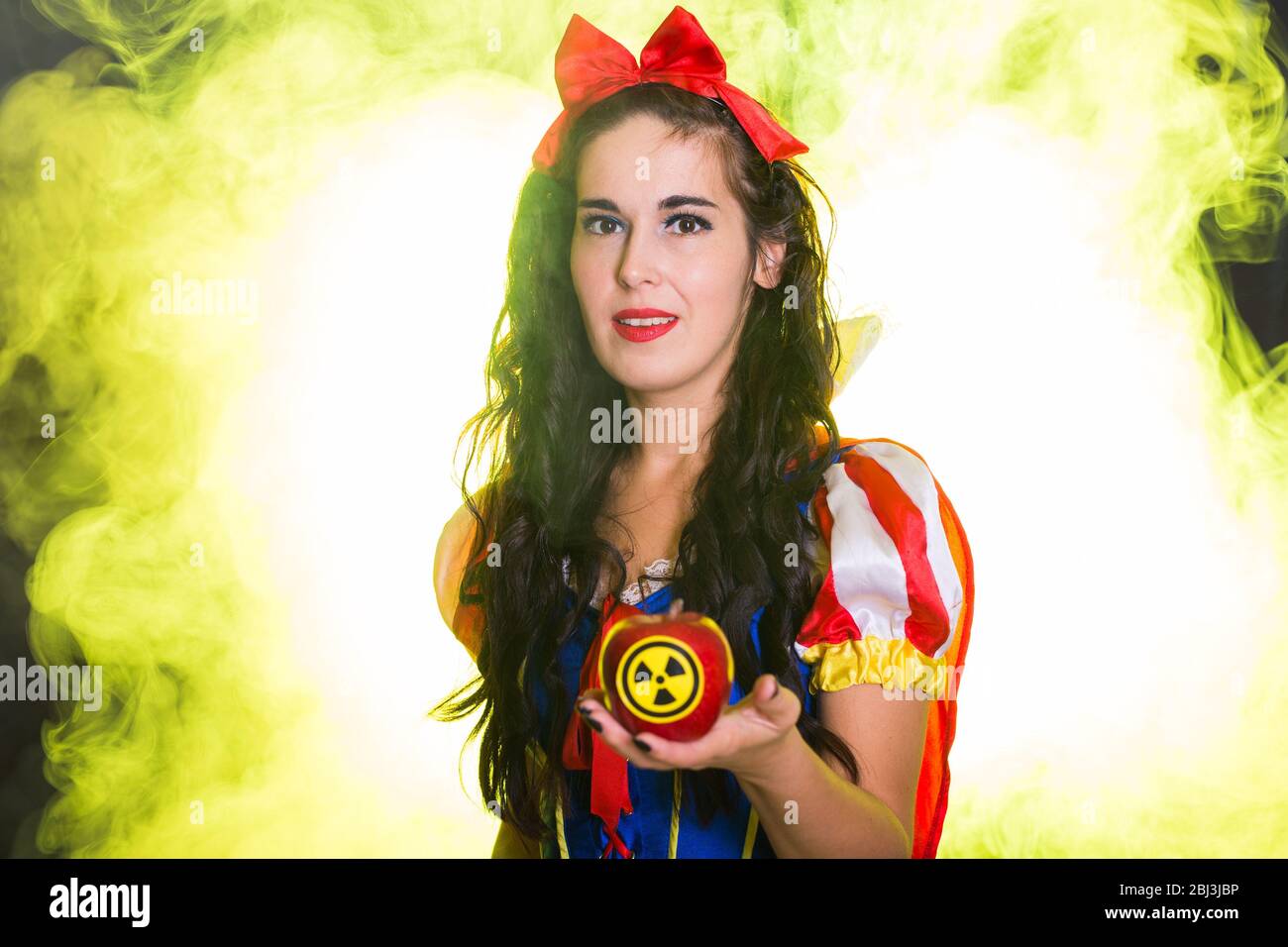 Woman holding hazardous radioactive apple. Nuclear and radiation ...