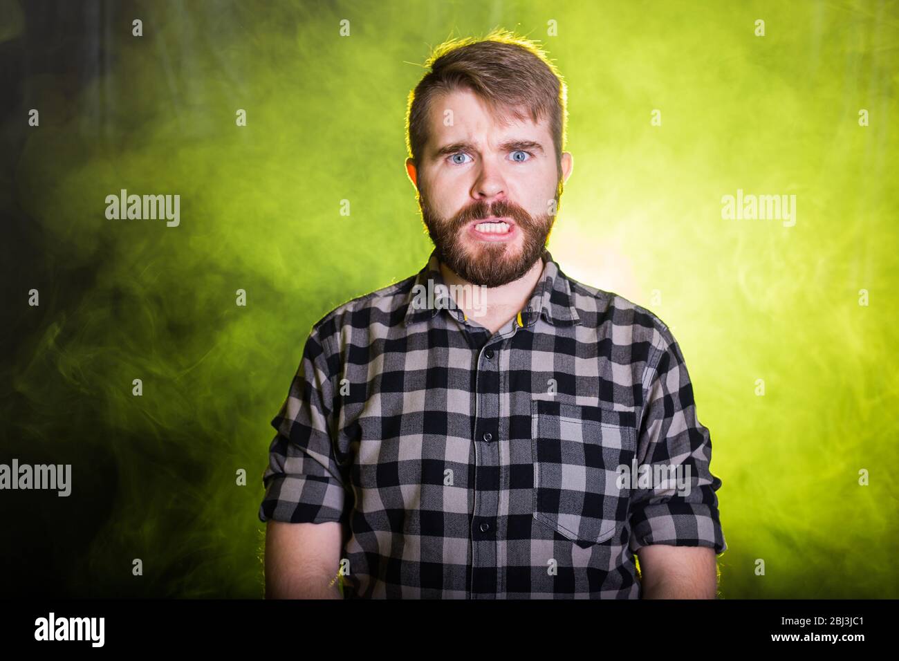 Portrait of strange man making stupid angry face Stock Photo - Alamy