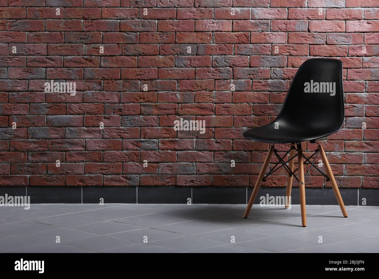 Chair on brick wall background Stock Photo - Alamy