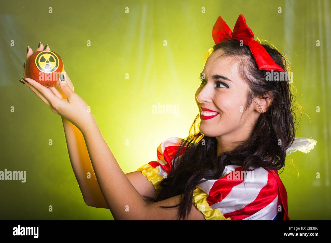 Woman holding hazardous radioactive apple. Nuclear and radiation ...
