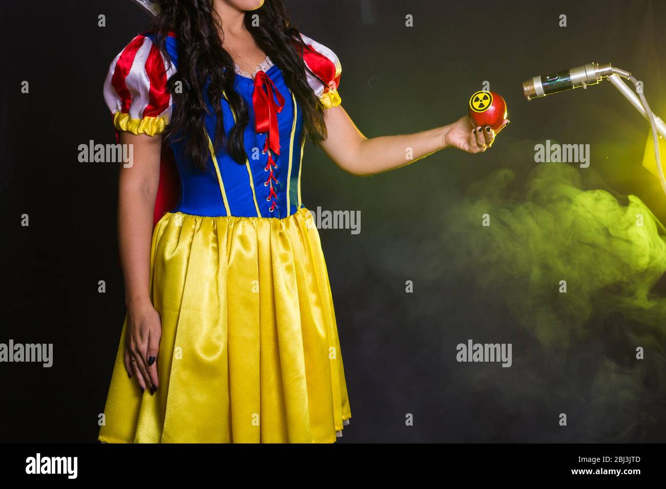 Woman holding hazardous radioactive apple. Nuclear and radiation ...