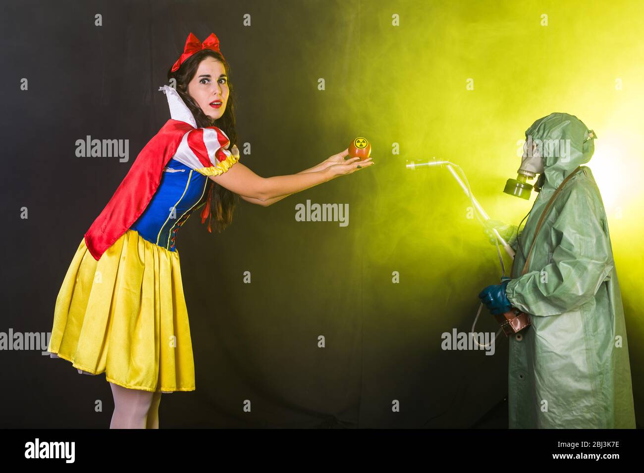 Danger, nuclear and radiation measurement - Girl holds apple with ...