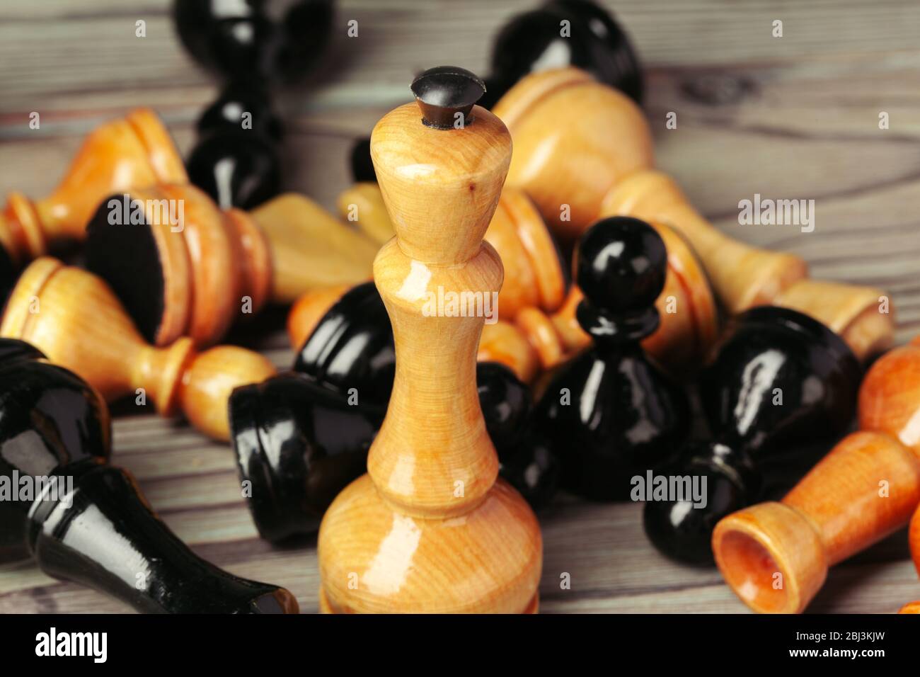 chess figures on brown woden table background Stock Photo - Alamy