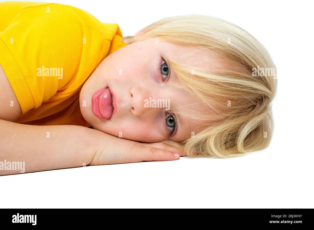 Tired boy lying isolated on white Stock Photo - Alamy