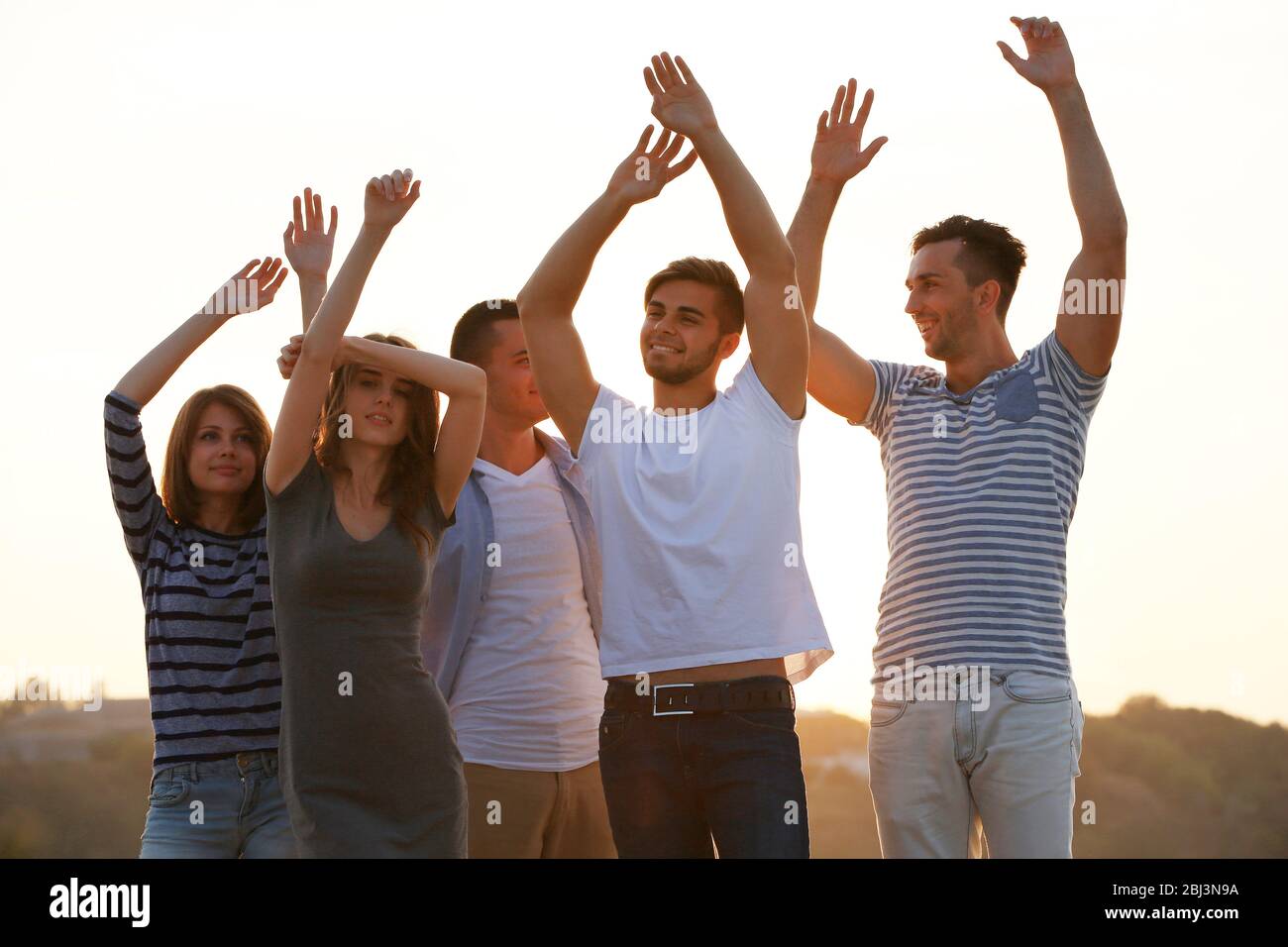 Young people on the riverside Stock Photo - Alamy