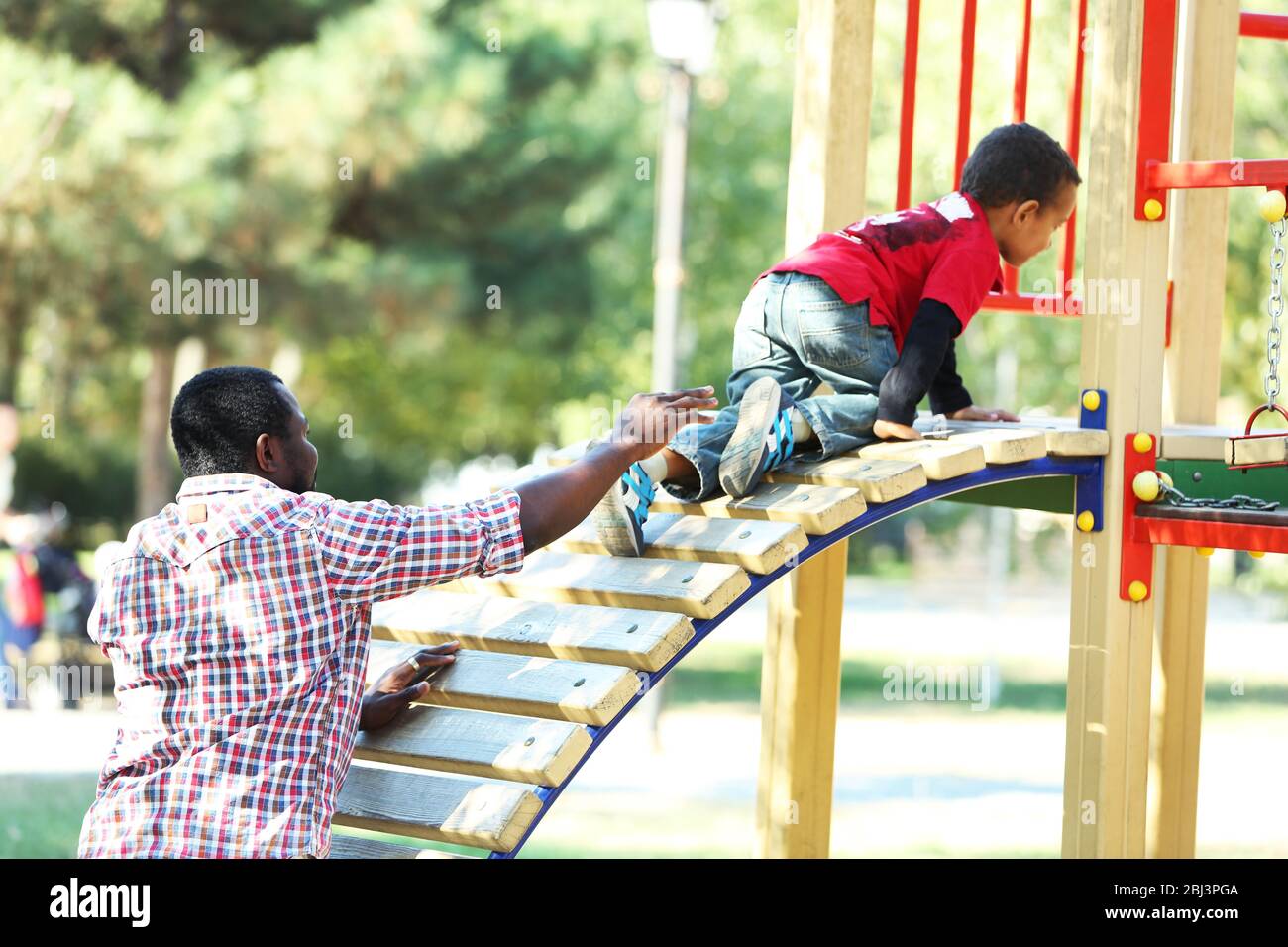 Father and son playing on the children playground Stock Photo - Alamy