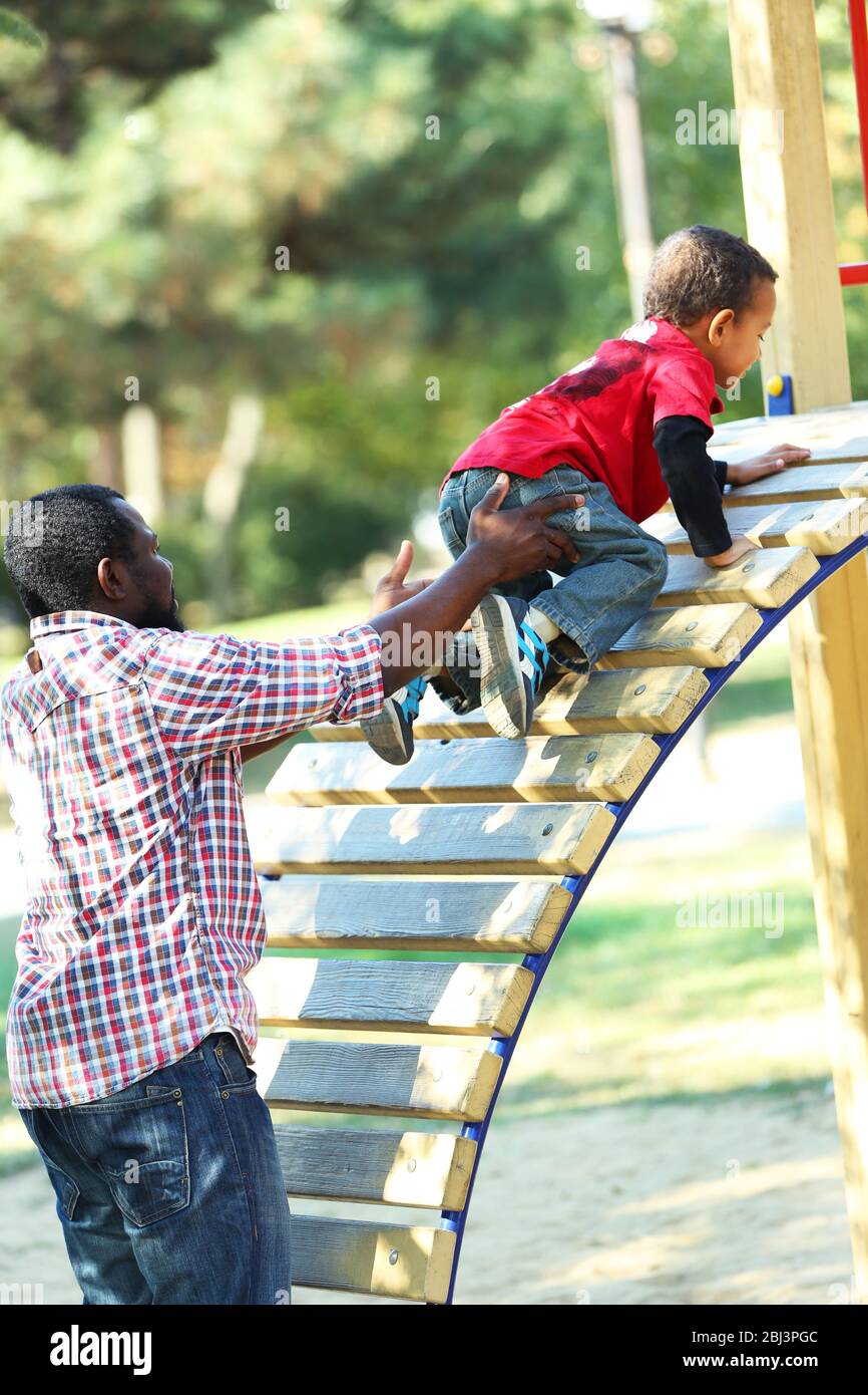 Father and son playing on the children playground Stock Photo - Alamy