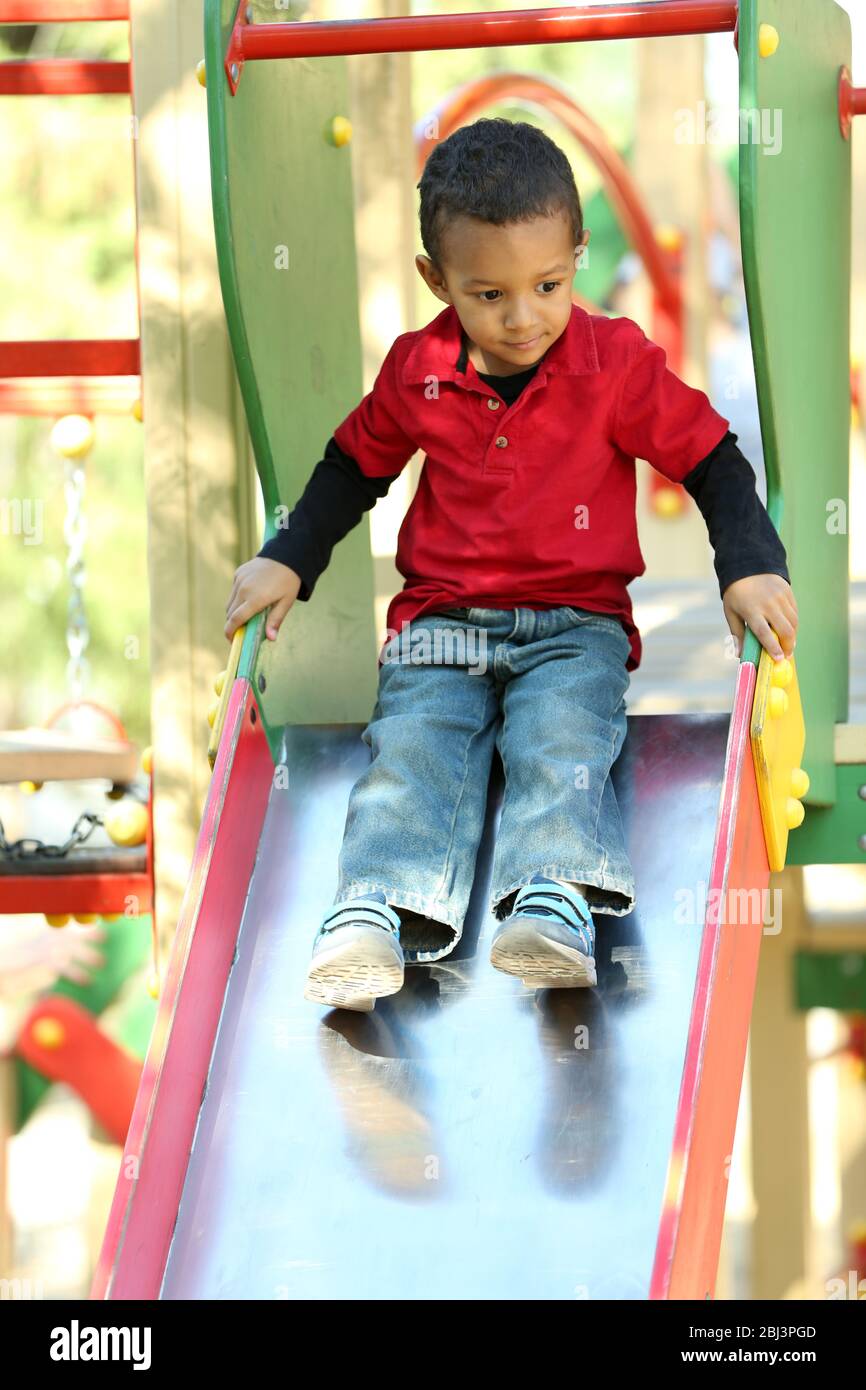 Little boy playing on the children playground Stock Photo - Alamy