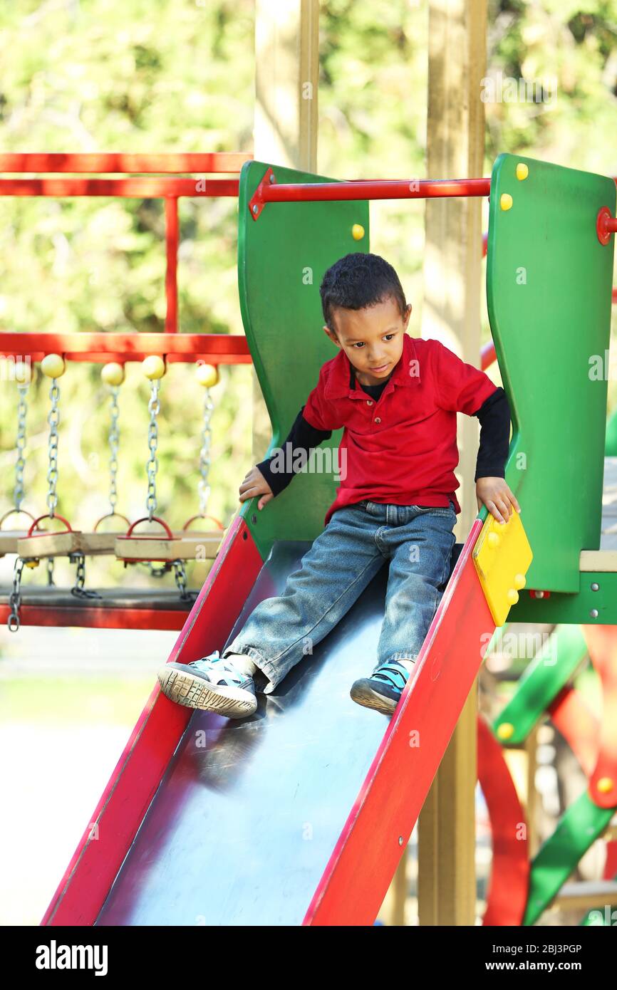 Little boy playing on the children playground Stock Photo - Alamy