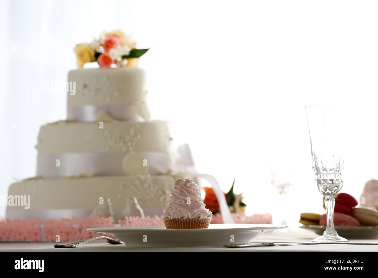 Wedding layered cake in decorated restaurant on window background Stock ...